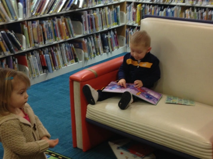 Children Talking Quietly In Library